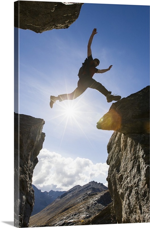 Hiker Leaping Between Rocks In The Brooks Range, Gates Of The Arctic ...