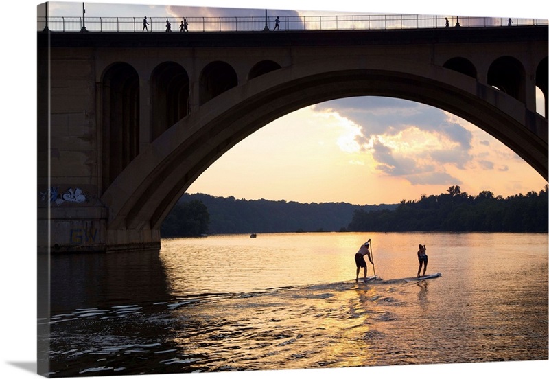Paddleboarders glide on the Potomac River under the Key Bridge in ...