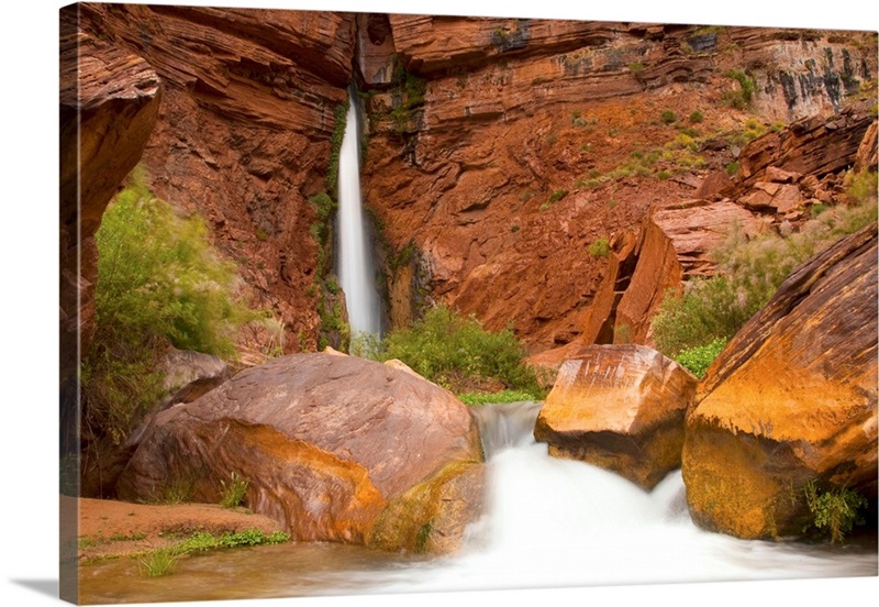 Waterfall from a narrow crevass in a sandstone cliff. | Great Big Canvas