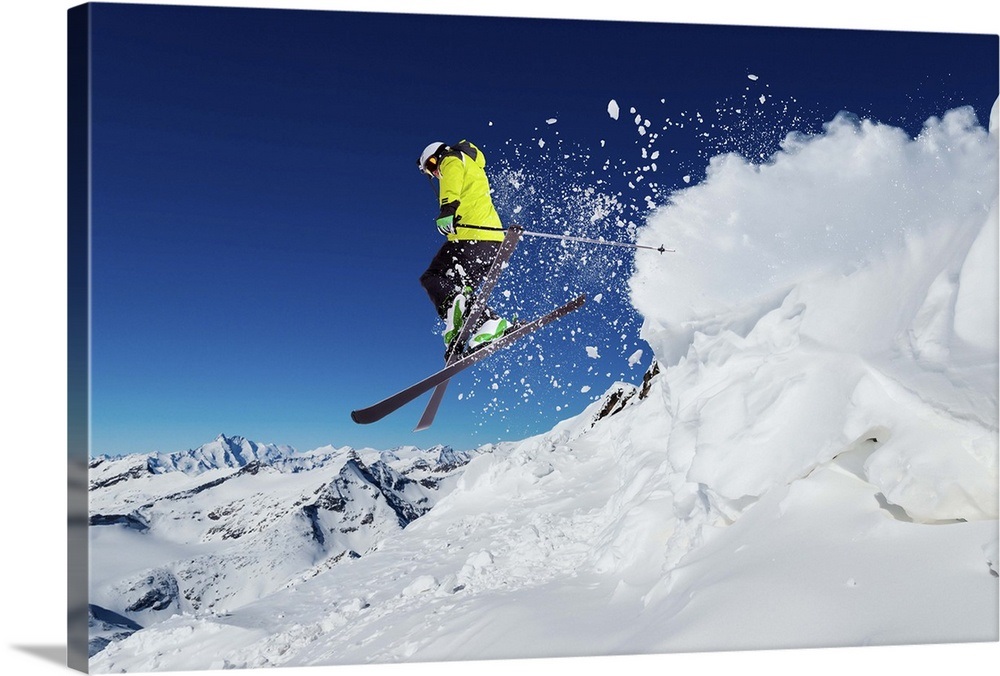 Alpine skier skiing downhill, blue sky in background Wall Art, Canvas ...