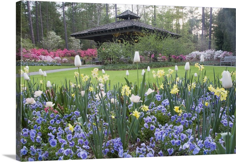 A covered pavilion in a garden of spring flowers | Great Big Canvas