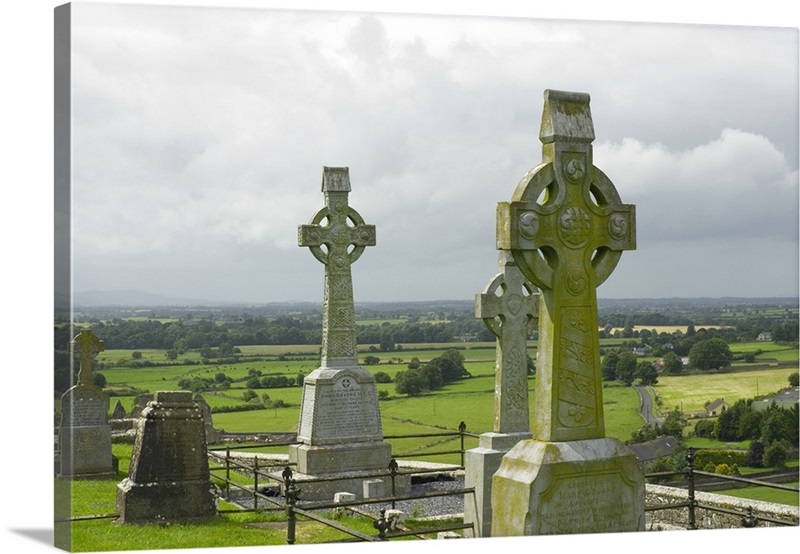 Ireland, Tipperary, Cashel. View of celtic cross and farmland beyond ...