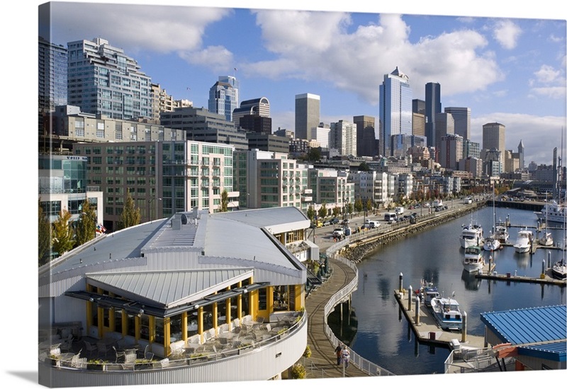 Puffy clouds over Seattle, Washington skyline with boats in the ...