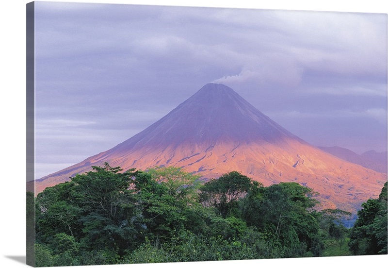 Sunset light peers through the clouds to illuminate the flanks of ...