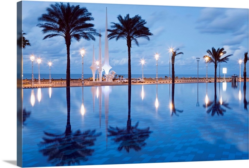 Egypt, Alexandria, Monument and palm trees at the Bibliotheca ...