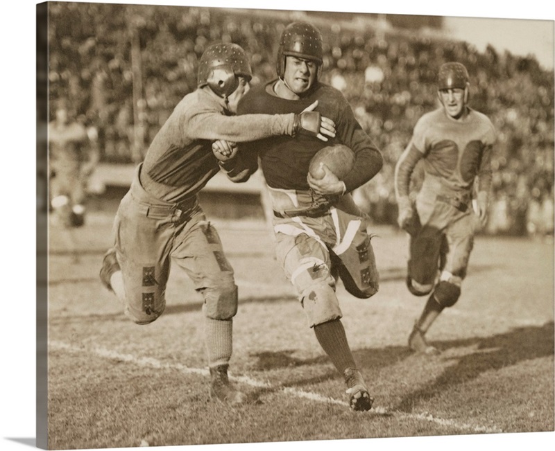 1920's football action. Hundreds of spectators watch from stadium seats ...