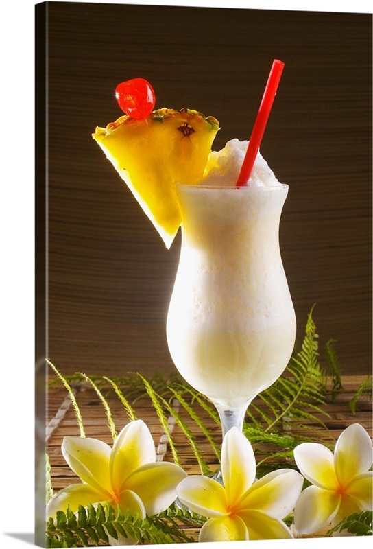 A pina colada garnished with fruit and flowers. | Great Big Canvas