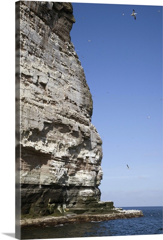 a tall rock face on the water's edge | Great Big Canvas