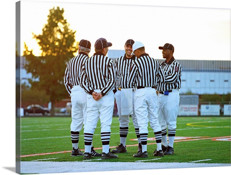 American football referees talking in field | Great Big Canvas