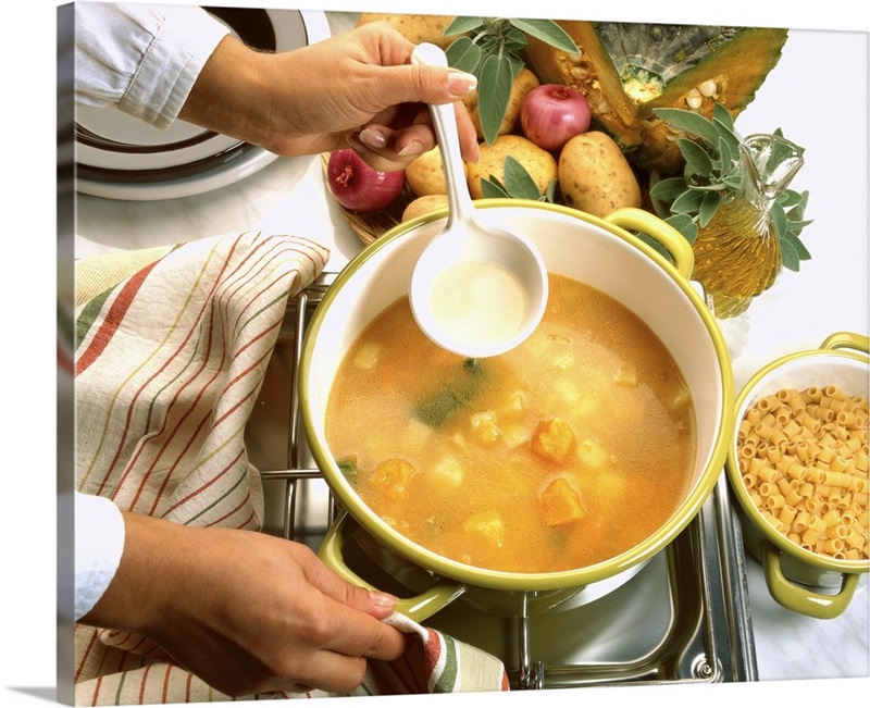 Close-up of a hand stirring a bowl of soup cooking on a stove | Great ...