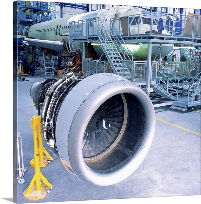 close-up of an aircrafts engine turbine kept in a hanger for assembly ...