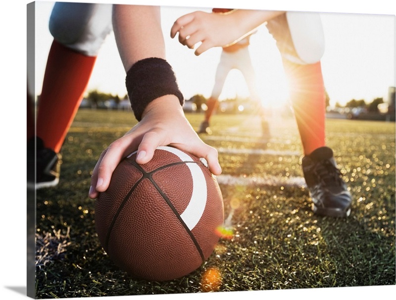 Close up of football center preparing to snap football | Great Big Canvas