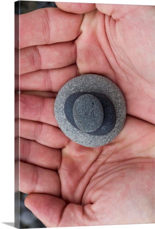 Close up of stacked rocks in hand | Great Big Canvas