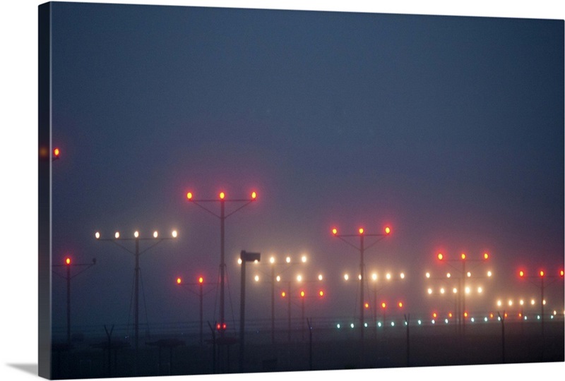 Colorful fogbound landing lights guide airplanes to runway. | Great Big ...
