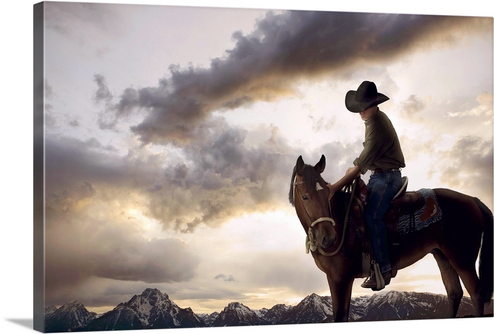 Cowboy on horse looking at mountain range, dusk, low angle view Wall ...
