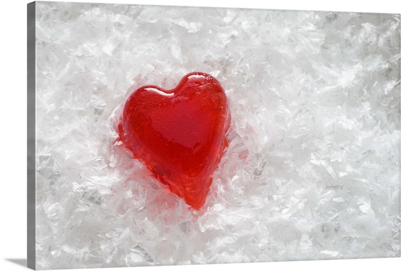 Frozen red ice-cube heart in ice flakes | Great Big Canvas