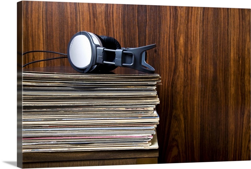 Headphones laying on stack of vinyl records | Great Big Canvas