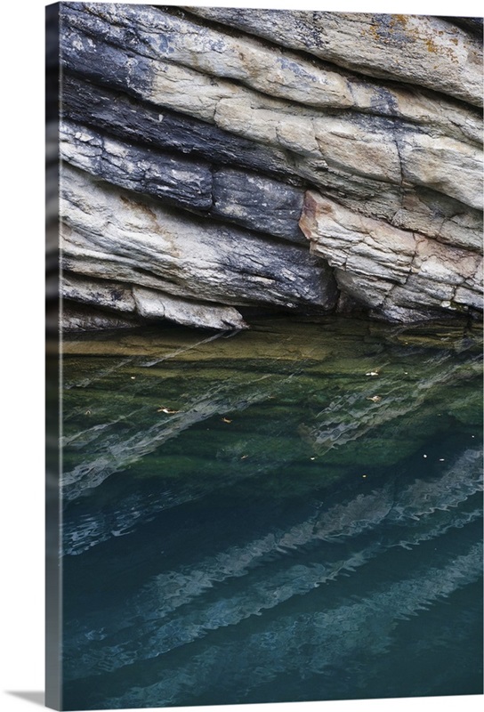 layers of rock reflected in a blue-green lake | Great Big Canvas