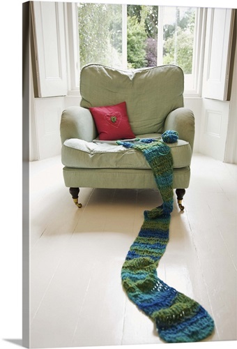 Long knitted scarf on chair | Great Big Canvas