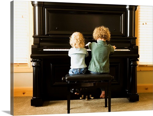 Rear view of two children sitting at upright piano | Great Big Canvas
