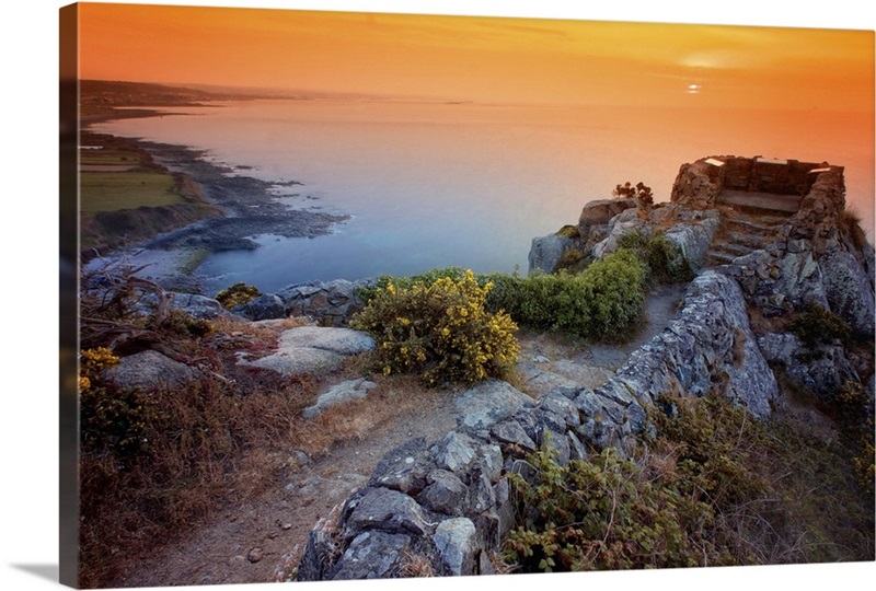 Stone wall by Atlantic ocean at sunset. | Great Big Canvas