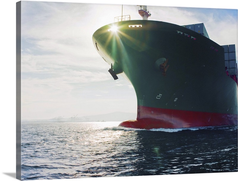 Sun shining through bow of cargo ship | Great Big Canvas