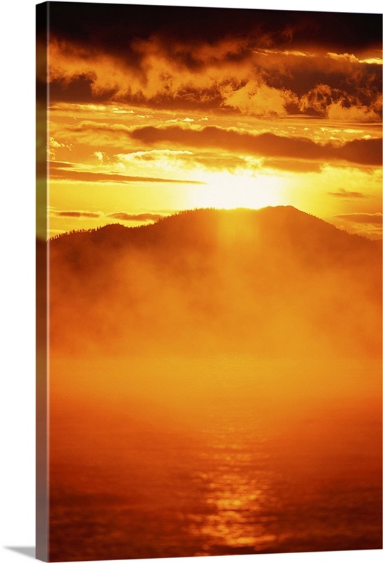 Sunset view of mist rising from lake, mountains in background | Great ...