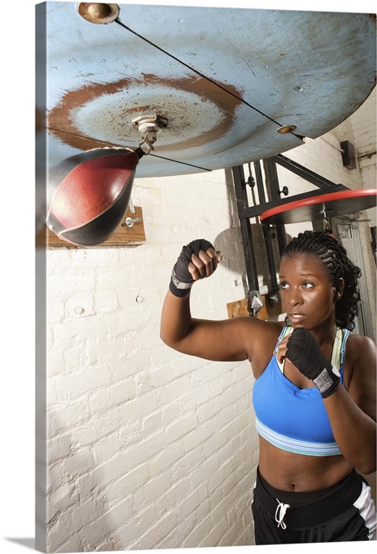 Woman boxer hitting speed bag | Great Big Canvas