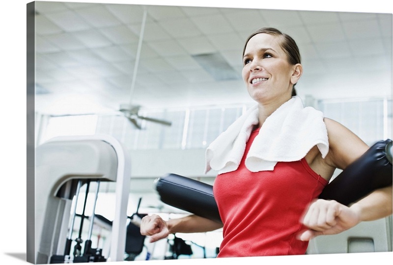 Woman on exercise equipment | Great Big Canvas