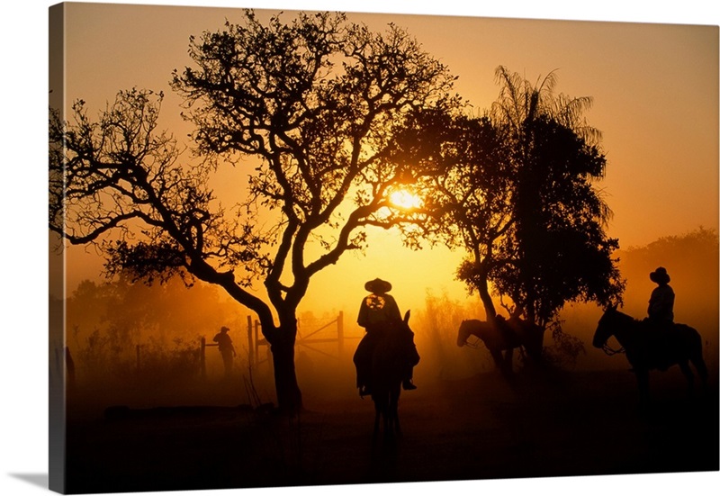 Cowboys On Horseback Silhouetted Against The Setting Sun | Great Big Canvas
