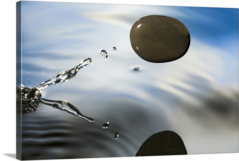 A rock skipping across the water's surface | Great Big Canvas
