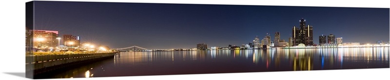 Buildings in a city lit up at dusk, Detroit River, Detroit, Michigan ...