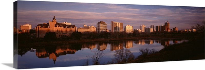 Canada, Saskatchewan, Saskatoon, Buildings along a river | Great Big Canvas