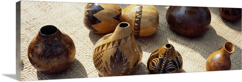 Decorated gourds named Ipu used as Hula rhythm instruments on a mat ...