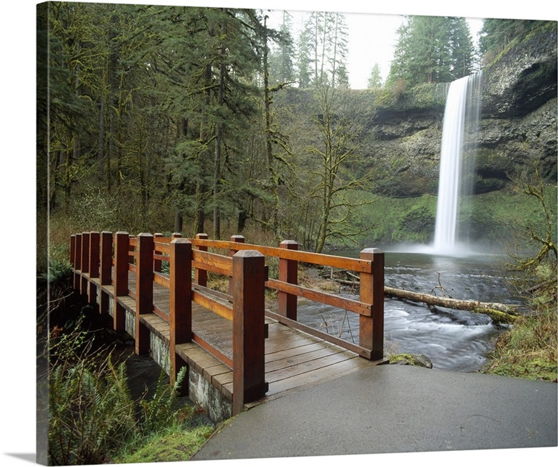 Footbridge across a river with a waterfall in the background Silver ...