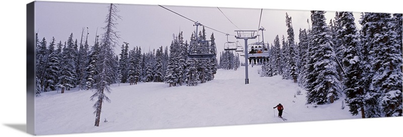 Ski lift passing over a snow covered landscape, Keystone Resort ...
