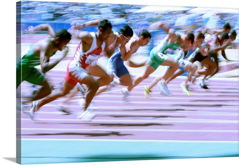 Blurred action at the start of a mens 100 meter track and field race ...