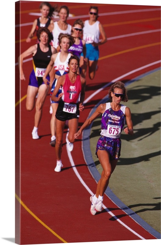 Female runners competing in a track race | Great Big Canvas