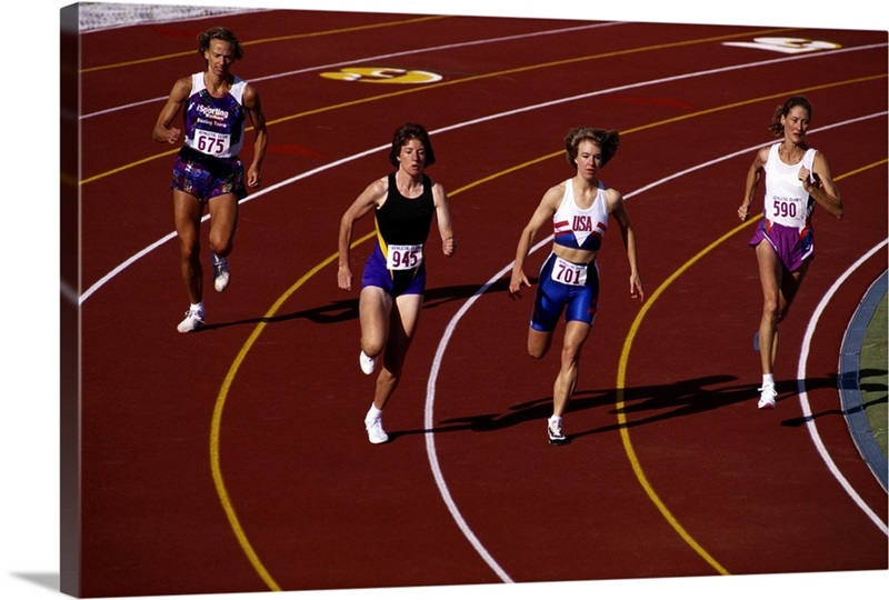 Female runners competing in a track race | Great Big Canvas