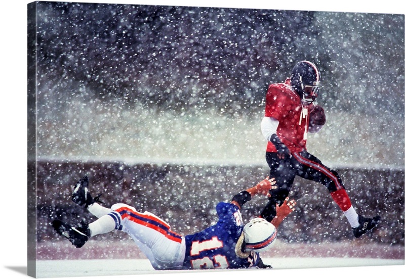 Football players in action during snowy game | Great Big Canvas