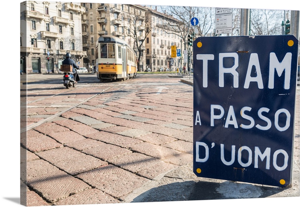 An old sign in Italian that says Trams go to Duomo, with a traditional ...