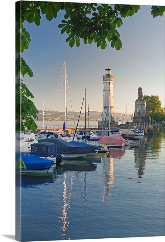 Lighthouse and Bavarian Lion at the port at sunset, Lake Constance ...