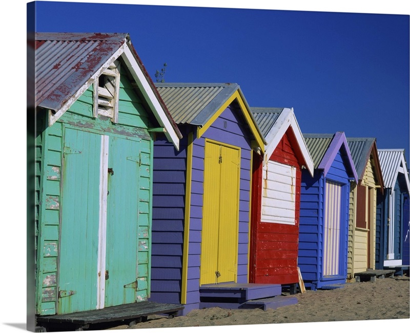 Row of beach huts painted in bright primary colours, Brighton Beach ...