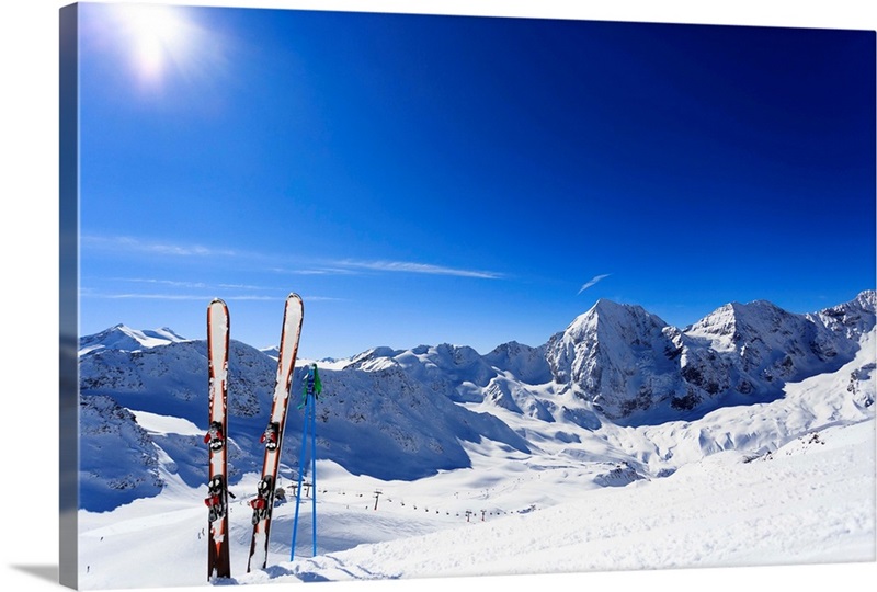 Skis sticking in the snow on a mountain slope. | Great Big Canvas