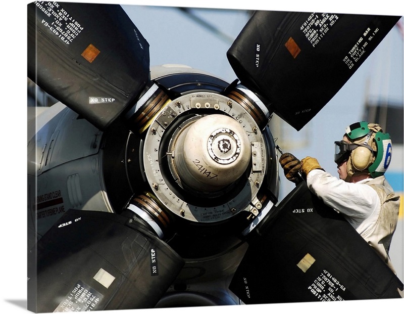 A Sailor Performs Maintenance On The Propeller Of An E-2C Hawkeye Wall ...