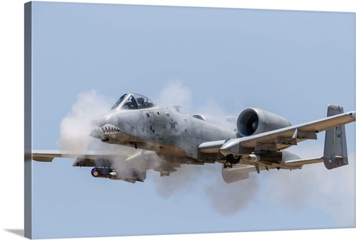 A US Air Force A-10 Thunderbolt II fires its 30mm gun at a strafe ...