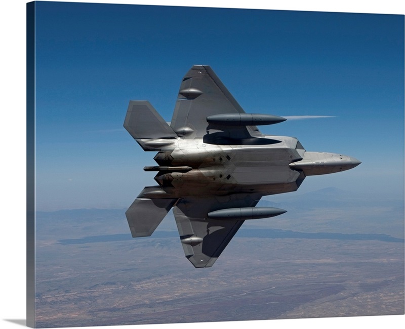 An F-22 Raptor maneuvers while flying a training mission over New ...