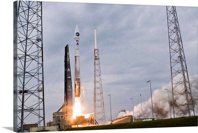 Fire and smoke signal the liftoff of the Atlas V/Centaur launch vehicle ...