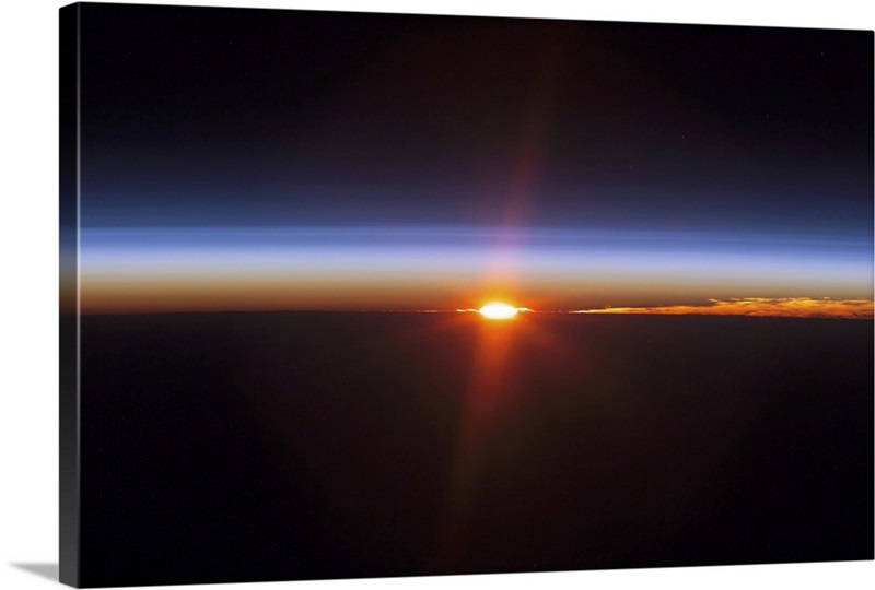 Layers of Earths atmosphere brightly colored as the sun sets over South ...
