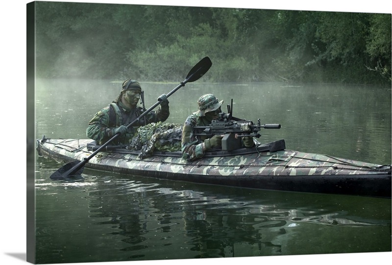 Navy SEALs navigate the waters in a folding kayak during jungle warfare ...